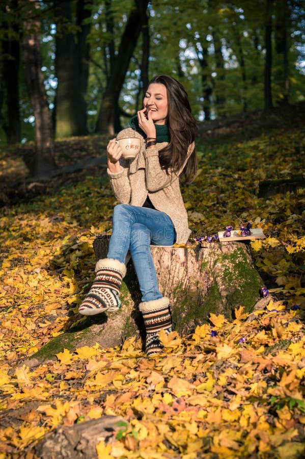 Girl sitting on tree stump stock photo. Image of leaves - 86321424
