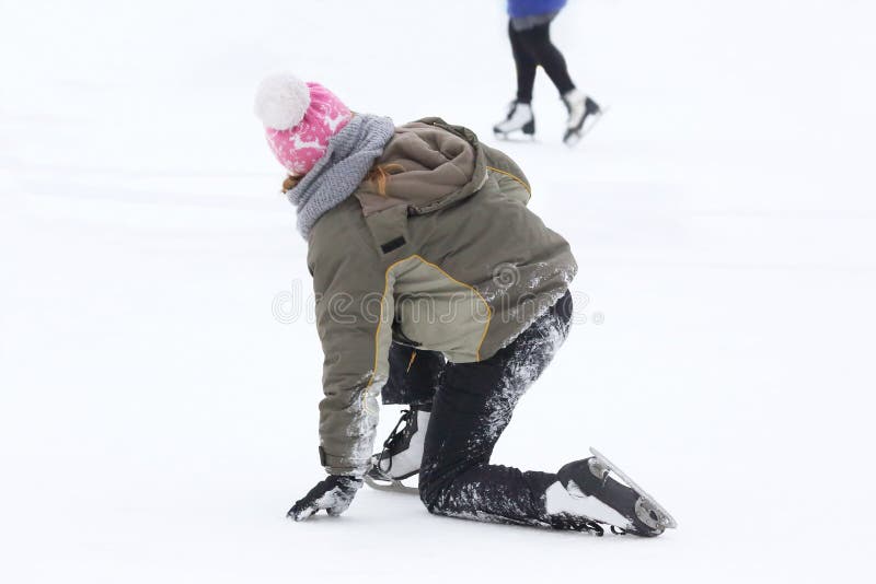 Girl on the Skates Rises after a Fall on the Ice Rink Stock Photo ...