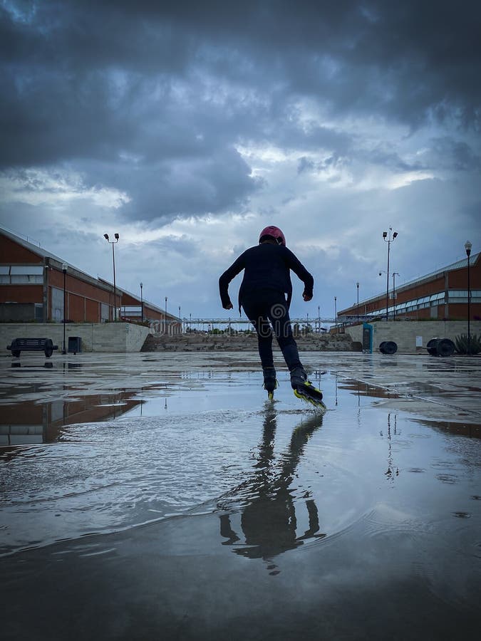 Girl Skating in the City, Her Reflection in the Water Stock Image ...