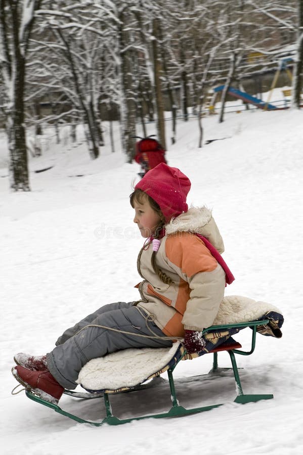 Girl sledding down a hill stock image. Image of sled - 42977865