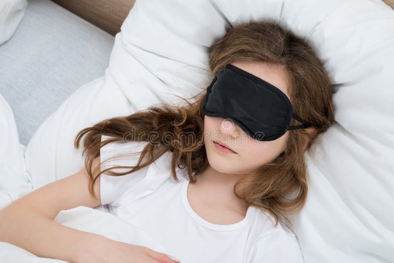 Girl Sleeping on Bed with Sleep Mask Stock Image - Image of bedding ...