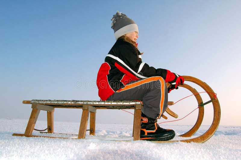 Girl on a sleigh stock image. Image of recreation, snow - 12588673