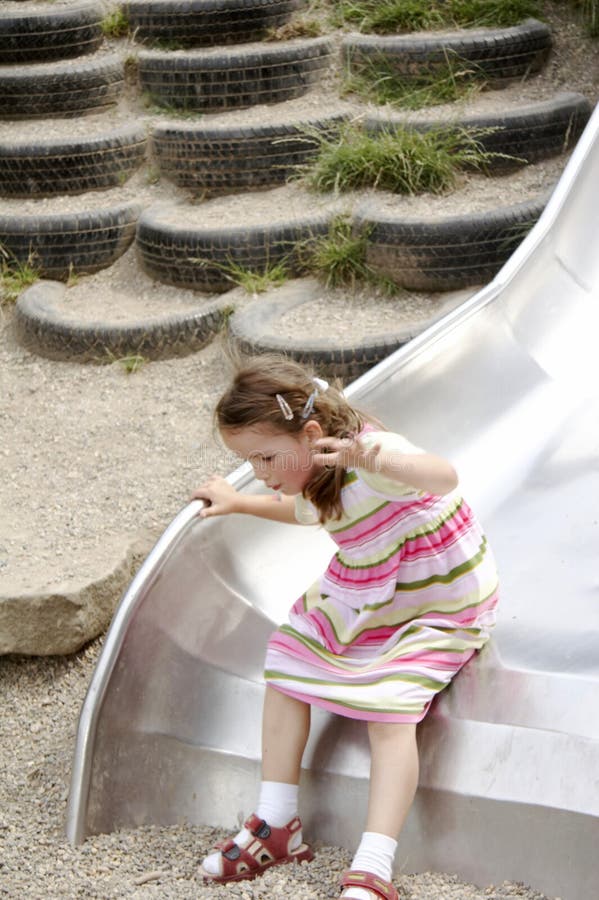 Girl on a slide 01 stock image. Image of small, happy, unconcerned - 920819