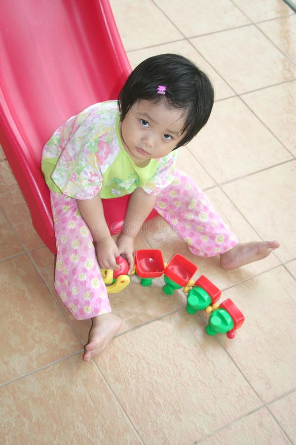 Little girl on a slide stock image. Image of blue, sliding - 32826915