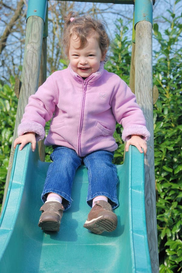 Girl on slide stock image. Image of sitting, slide, pink - 19259105