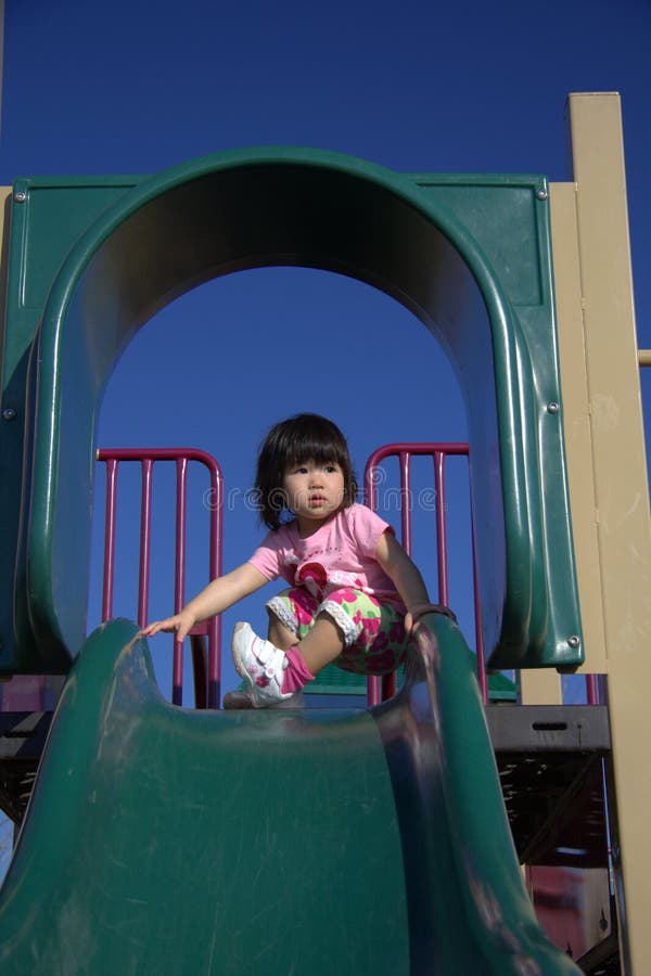 Girl on slide stock image. Image of playground, blue - 25003529