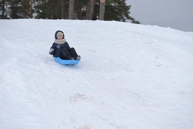 Girl Slides Down the Snow Slide and Smiles Stock Photo - Image of snow ...