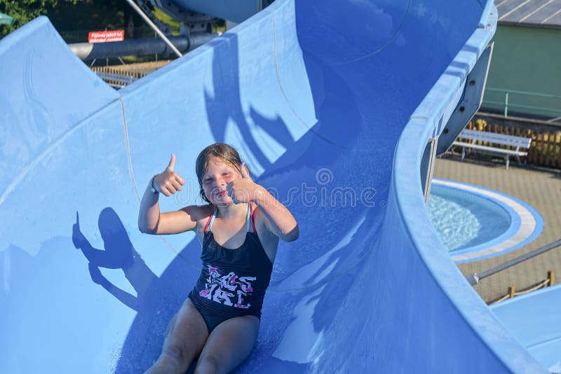 Girl Sliding Down On A Water Slide In Aqua Park Vacation Concept Stock