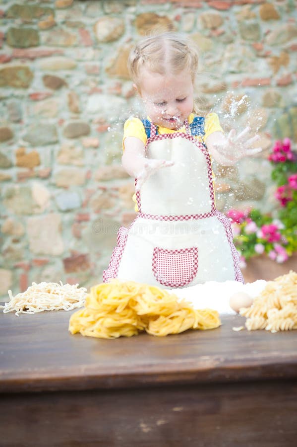 Girl Smashing an Egg into the Flour for Pasta. Stock Photo - Image of ...