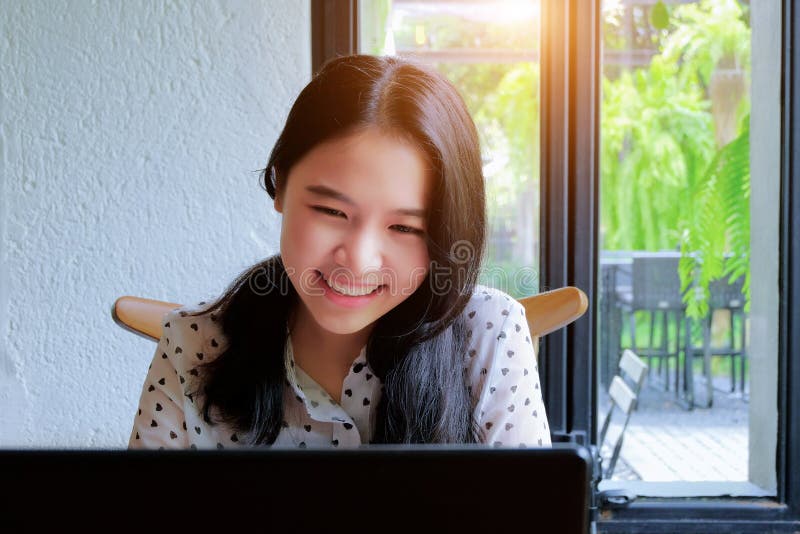 Girl Smiling while Typing on Computer. Stock Photo - Image of charming ...
