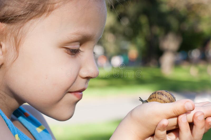 A girl with a snail stock image. Image of botanic, grass - 21819889