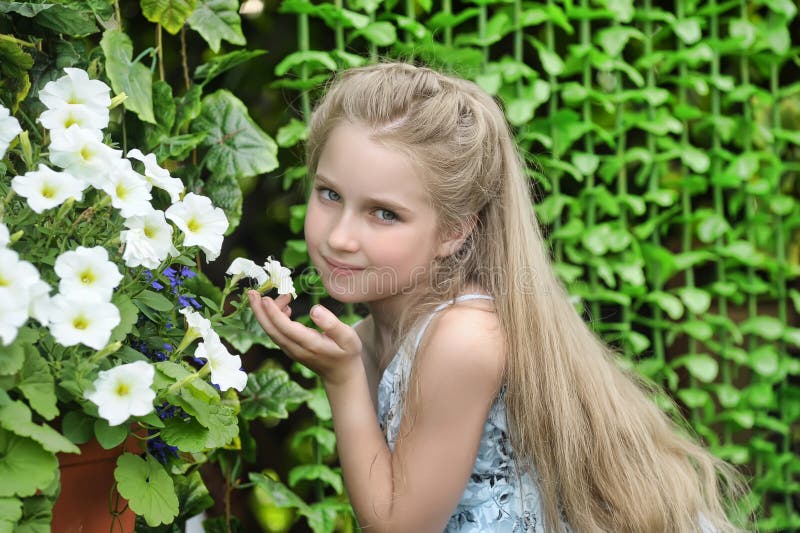 Girl sniffing flowers stock photo. Image of green, adult - 25937876