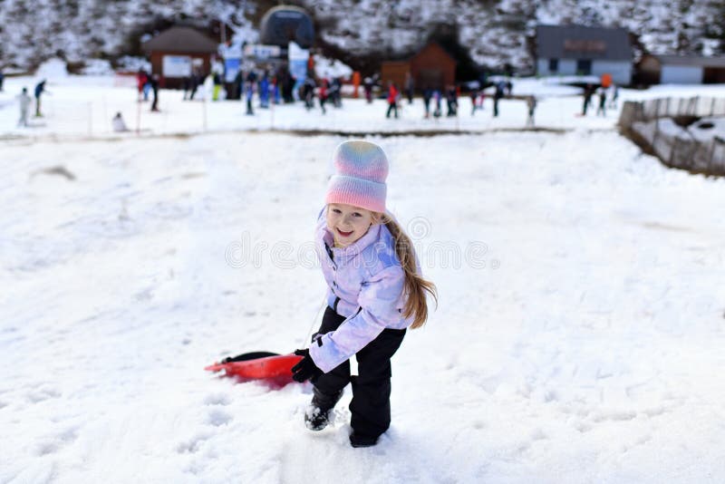 A Girl with Snow Bob Sledding in the Snow Stock Photo - Image of ...
