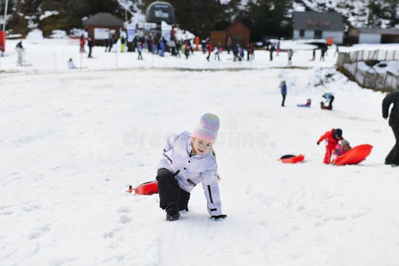 A Girl with Snow Bob Sledding in the Snow Stock Photo - Image of mother ...