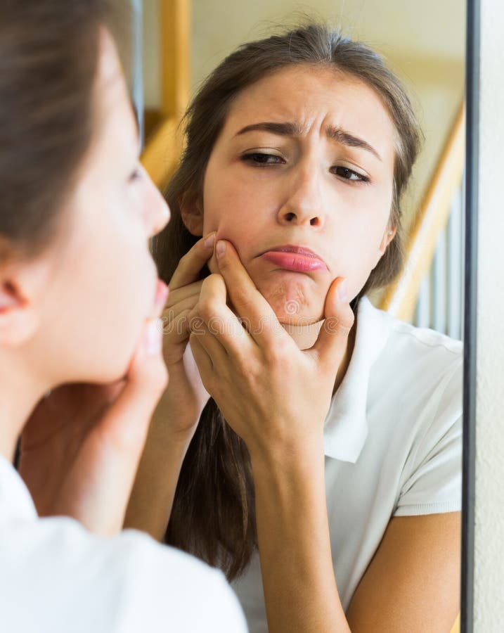 Girl squeezing pimple stock image. Image of facial, inside - 55345879
