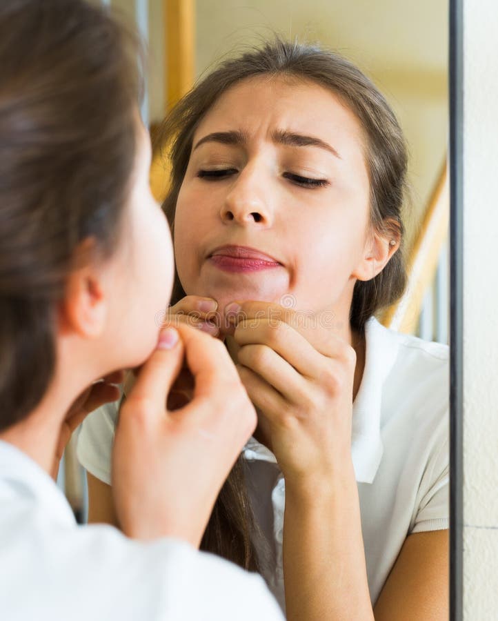 Guy popping a pimple stock image. Image of mirror, impurity - 54521551