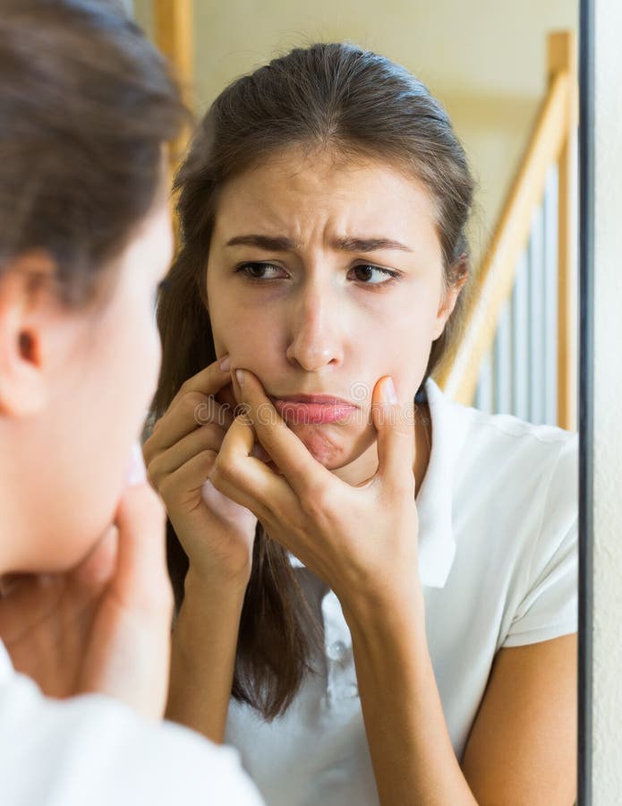 Girl squeezing pimple stock image. Image of hand, clean - 89612611