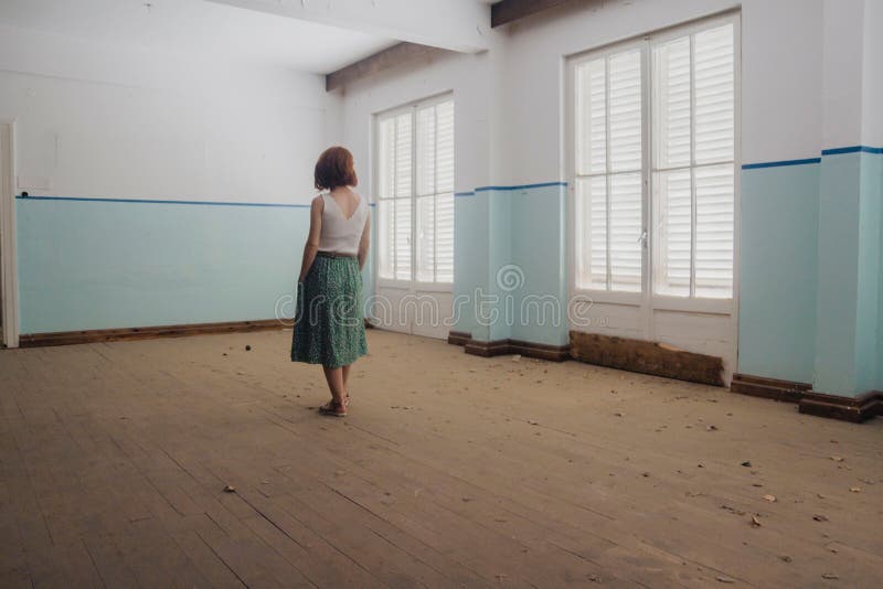Girl Standing in an Abandoned Empty House with Big Windows and Fallen ...