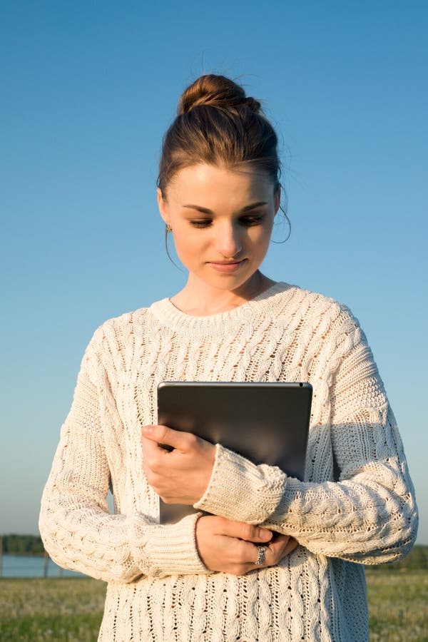 Girl Holding a Tablet Computer in the Sunset Light Stock Photo - Image ...
