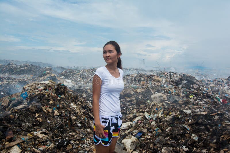 Girl Standing and Looking a Side Sad with Trash Around at Garbage Dump ...