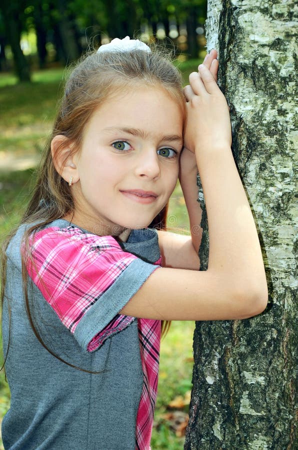 Girl standing near tree stock image. Image of beautiful - 21052143