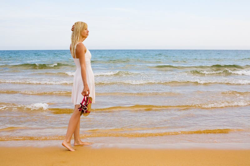 Girl standing on seashore stock photo. Image of blonde - 24168772