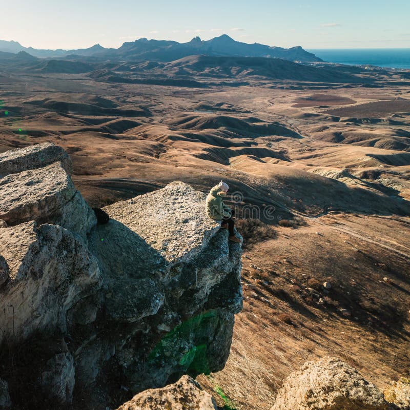 Girl Stands on the Edge of a Cliff Overlooking the Valley Stock Image ...
