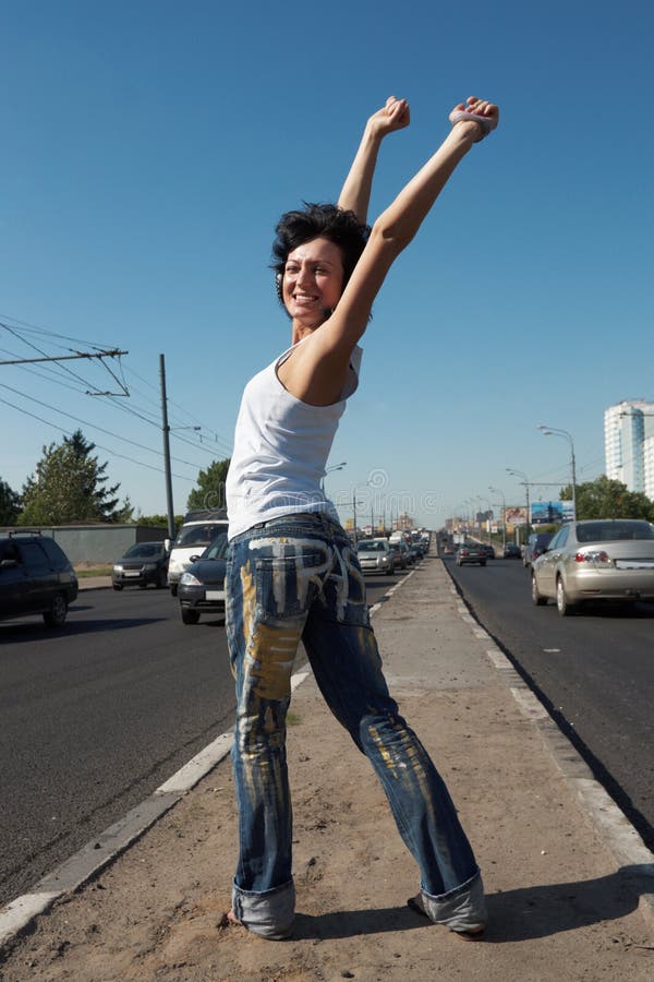 Girl Stands in Half-turn on Middle of Road Stock Photo - Image of ...