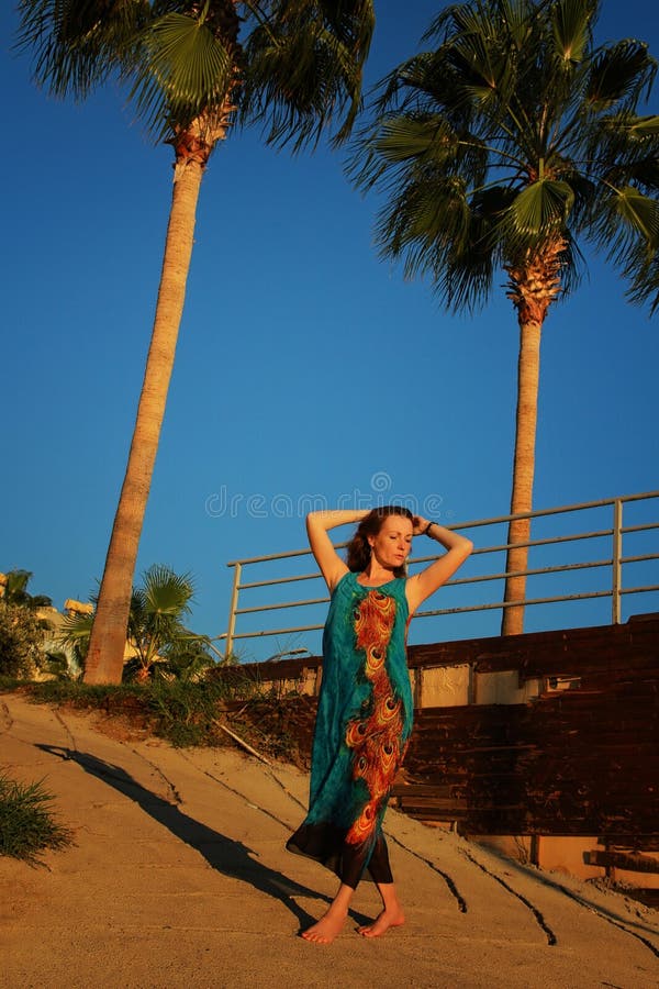 A Girl Stands Under Palm Trees at Sunset Stock Photo - Image of palm ...