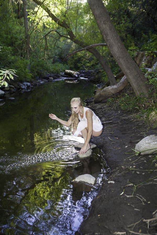Girl by stream stock photo. Image of outdoors, dress - 79336474