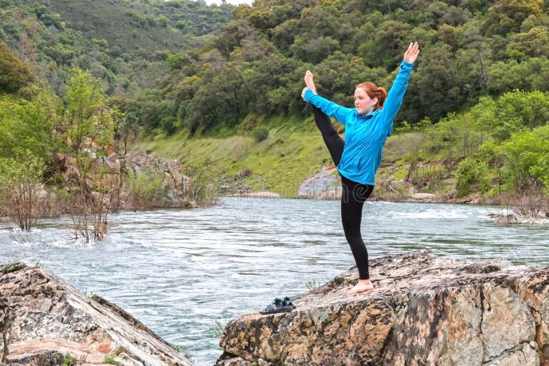 Girl Stretching on Rocks Near Fast River Stock Photo - Image of ...