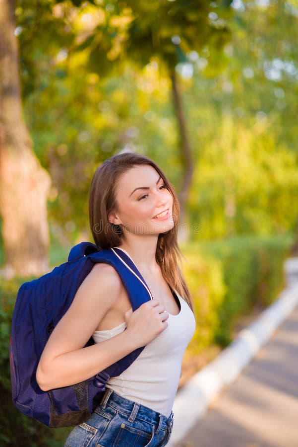 A Girl Student with a Backpack in Park Stock Photo - Image of color ...