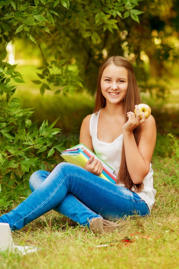 Girl Student with Books Eating an Apple Stock Photo - Image of internet ...
