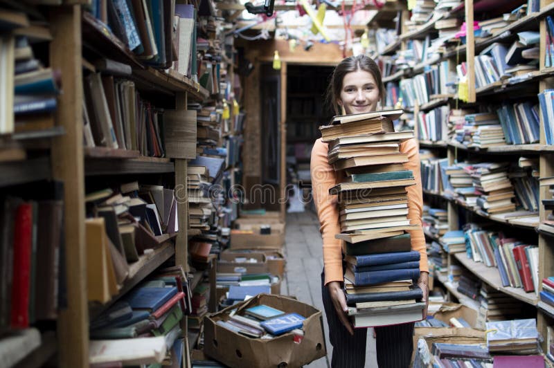 Girl Student Carries a Large Stack of Books in the Library, Preparation ...