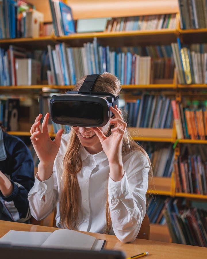 Girl Using Devices in the Library, a Laptop and VR Headset Stock Photo ...