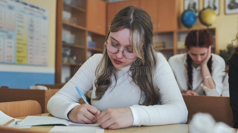 A Girl Student Writes Math Formulas in a Notebook. Stock Photo - Image ...