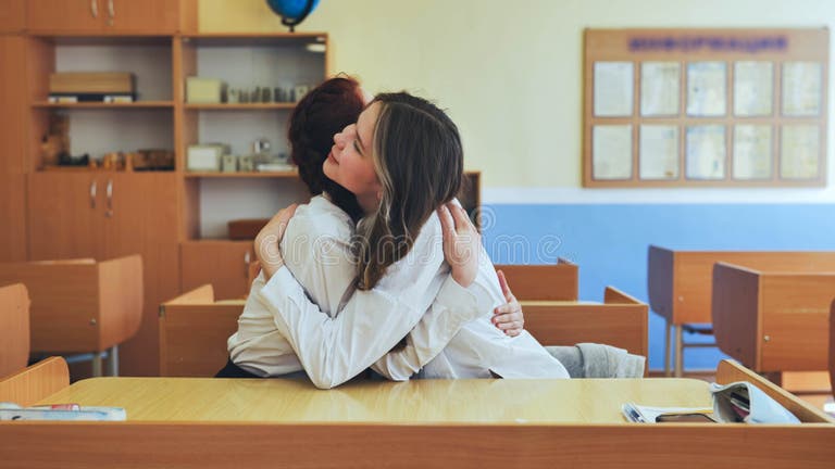 Girl Students Hugging in a Classroom at School. Stock Photo - Image of ...
