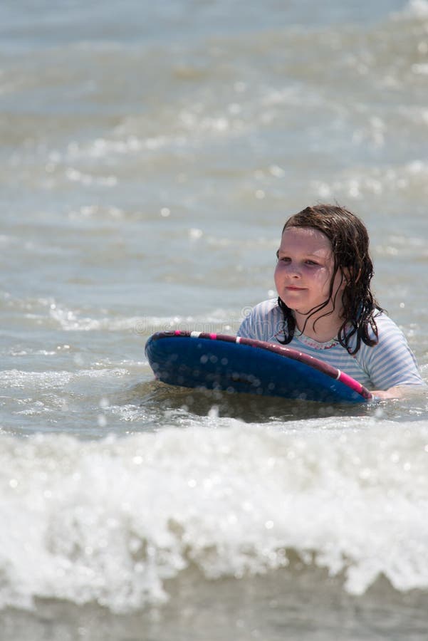 Girl Surfing the Waves in the Ocean on a Boogy Board Stock Image ...