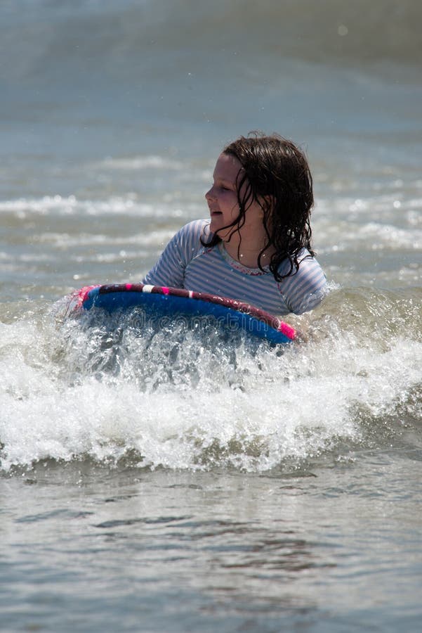 Girl Surfing the Waves in the Ocean on a Boogy Board Stock Photo ...