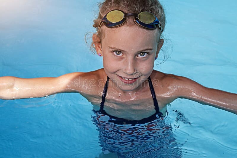 Girl swimming in a pool stock image. Image of learning - 48653163