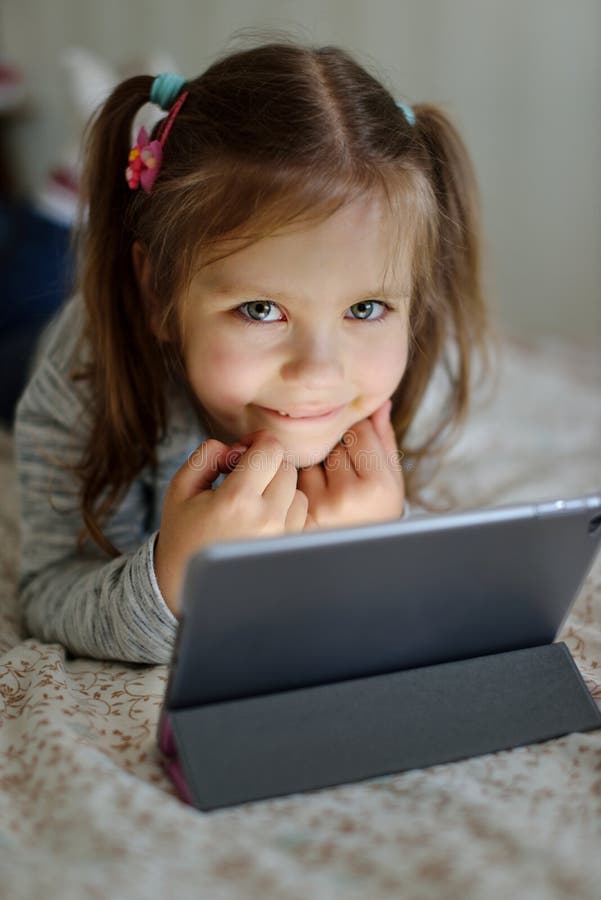 Girl with tablet pc stock photo. Image of couch, person - 92236786