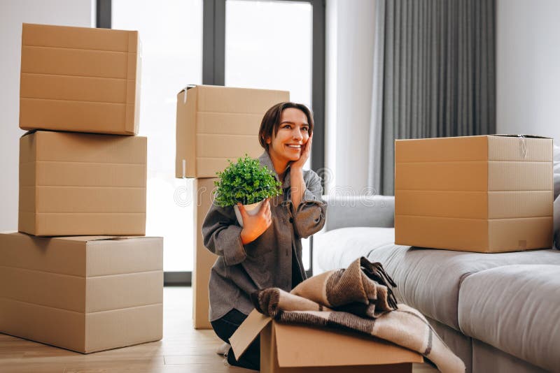 The Girl Takes Things Out of the Box from Which the Light Shines Stock ...