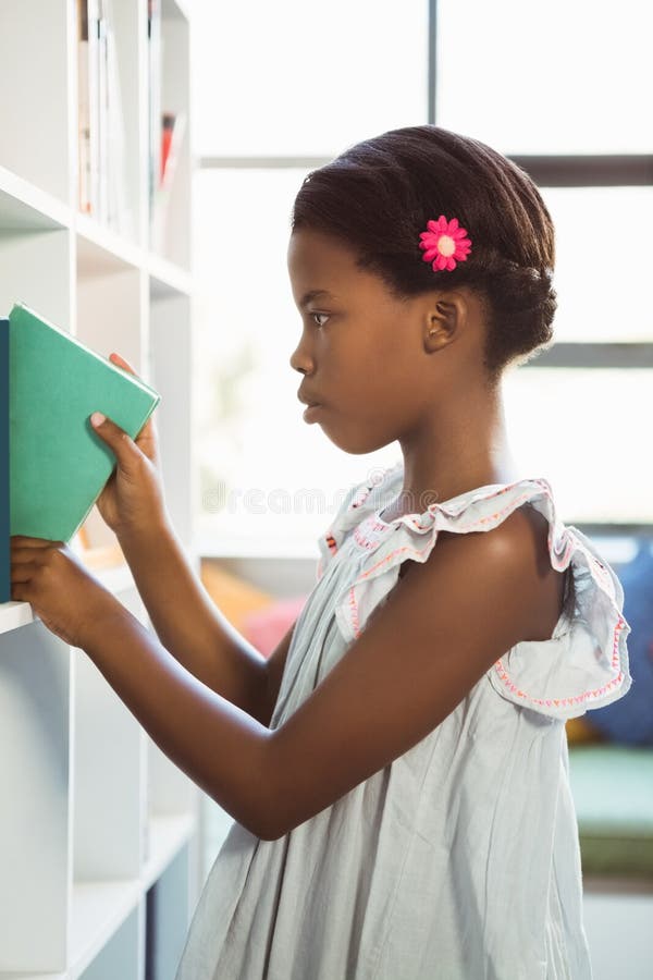 Girl Taking a Book from Bookshelf in Library Stock Image - Image of ...