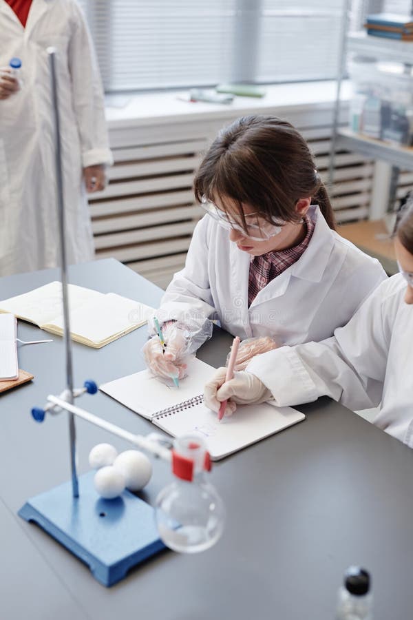 Girl Taking Notes on Practice Experiment in School Laboratory Stock ...