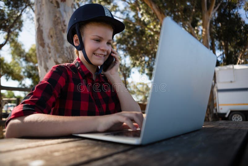 Girl Talking on Phone while Using Laptop Stock Image - Image of ...