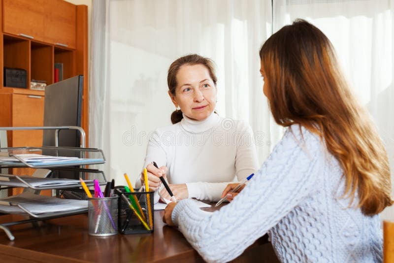 Girl Talking To Employee with Computer Stock Image - Image of older ...