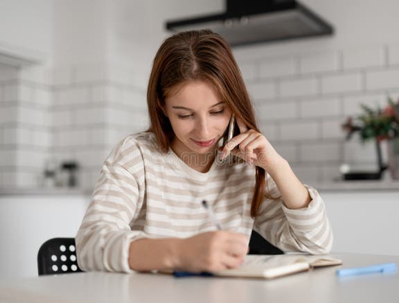 Girl Talks on Phone and Writes in Notebook Stock Image - Image of ...