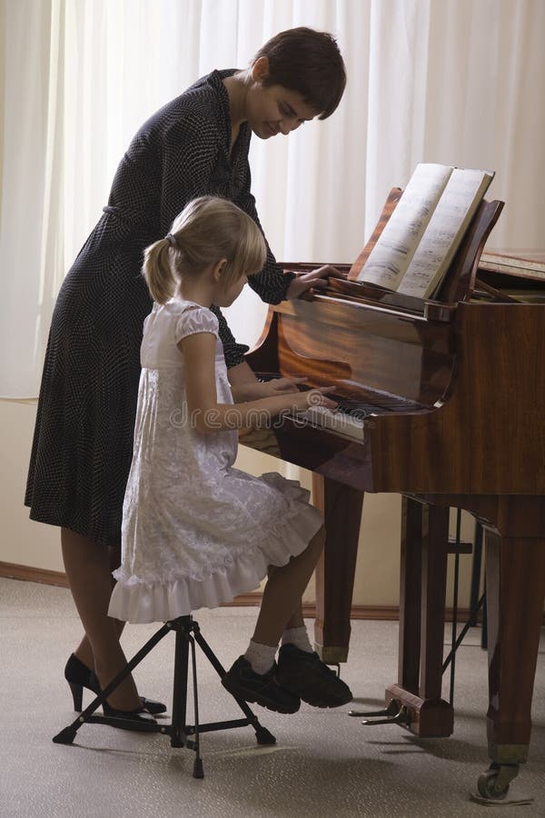 Girls Playing Piano stock photo. Image of education, blond - 5676694