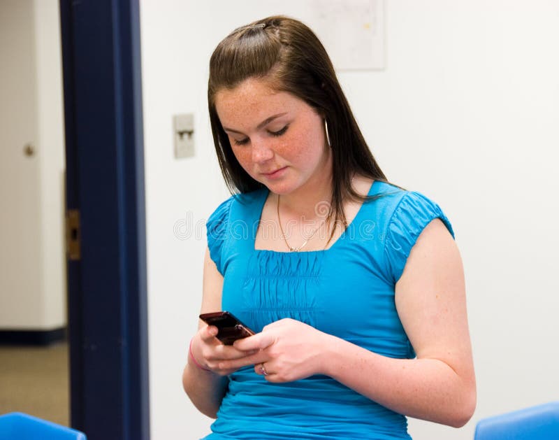 Girl Texting in a Classroom Stock Photo - Image of cellular, messaging ...