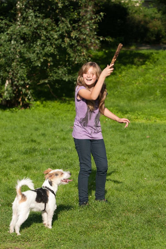 Girl Throwing Stick for Dog Stock Image - Image of happy, animal: 16569657